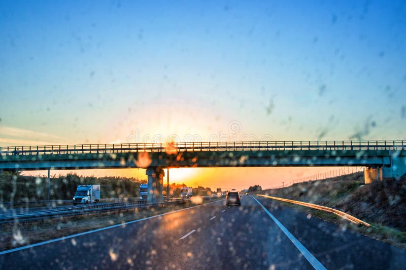 Highway and Bridge at Sunset through a Dirty Windshield, Emphasizing ...