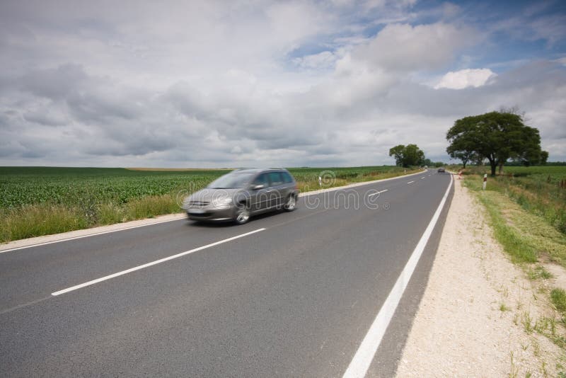 Highway with a fast car stock image. Image of grass, asphalt - 6188535