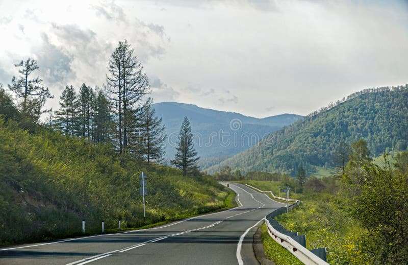 Highway through Hilly Terrain with Trees and Clouds on Blue Sky Stock ...