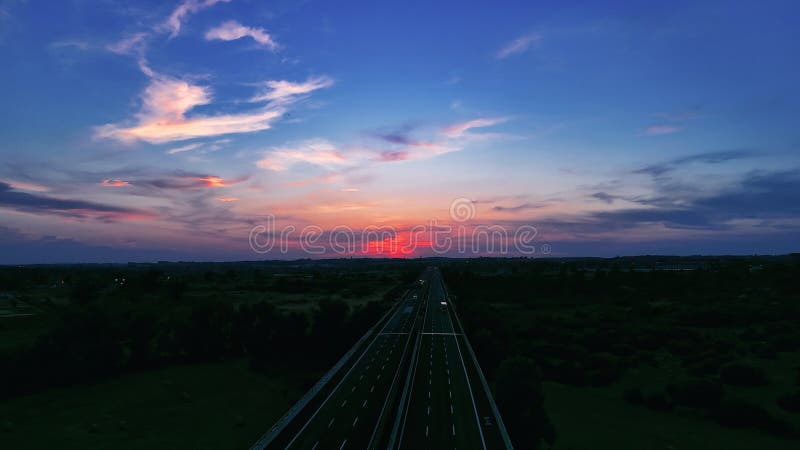 Highway Leading To the Beautiful Sunset Over Green Fields Stock Photo ...
