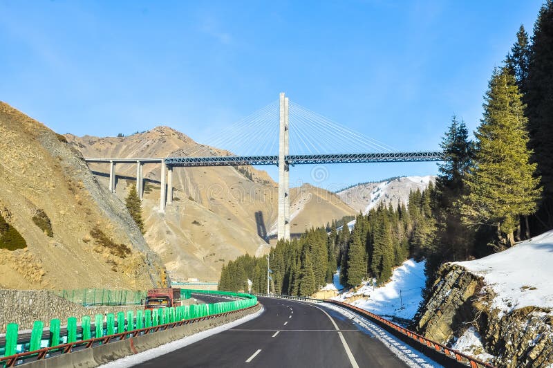 Highway in the Mountains and a Suspension Bridge Over it Stock Image ...