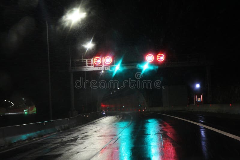 Highway at Night in the Rain with Colored Lights Reflections on the ...