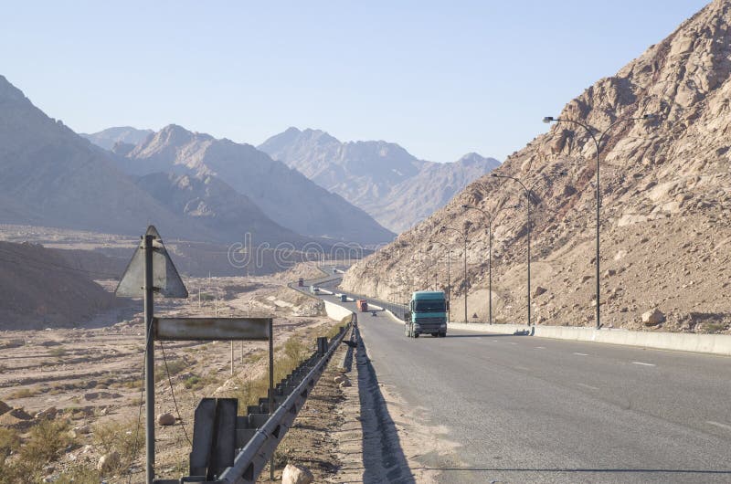 Highway in a Stone Desert and Trucks on the Road , Jordan Stock Photo ...