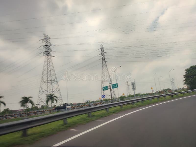 A Highway Street with Electrical Towers Stock Photo - Image of lane ...