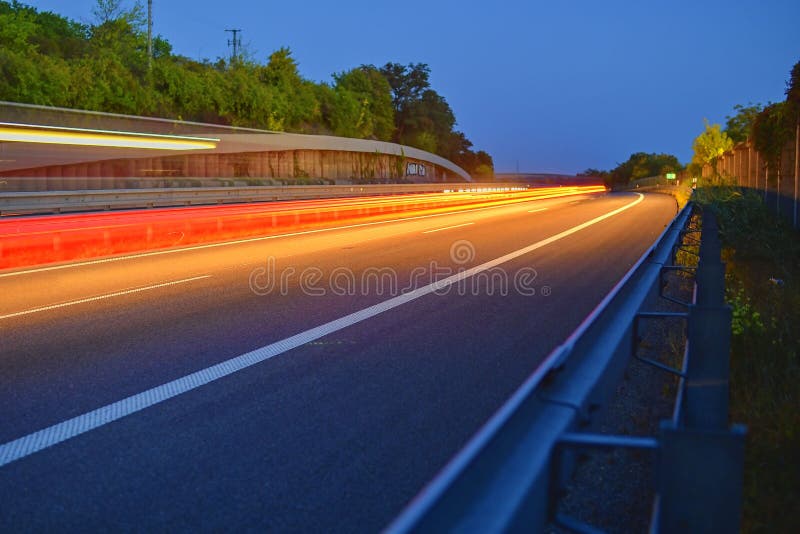 Highway at Twilight with Light Trails. High Traffic Road with ...
