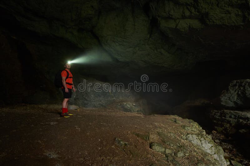 Hiker with Backpack Exploring a Cave Stock Image - Image of cave ...