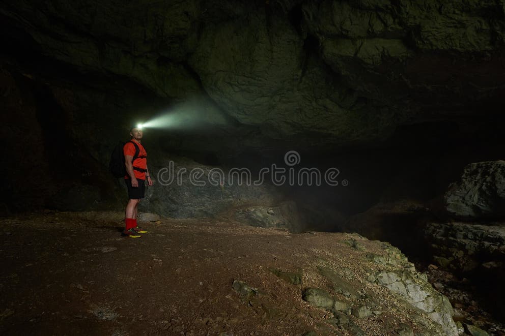 Hiker with Backpack Exploring a Cave Stock Image - Image of cave ...