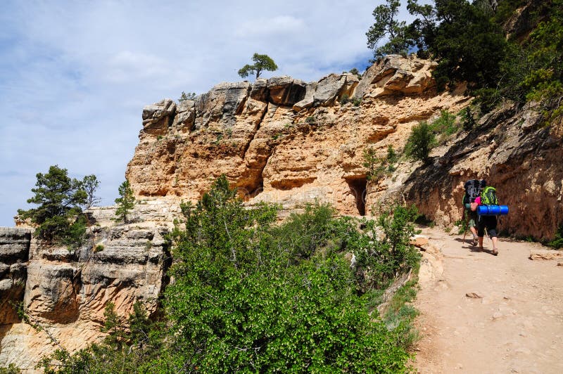 Hiker with Backpack on Rocky Grand Canyon Trail Under Clear Blue Sky ...