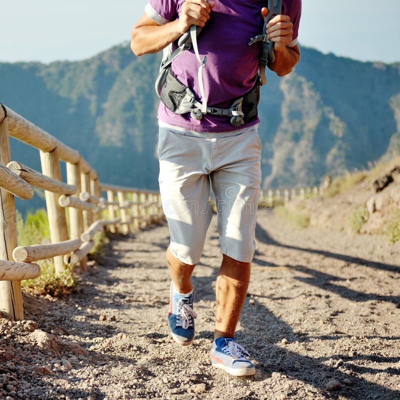 Hiker with Backpack Running on a Path of Mountain Stock Photo - Image ...