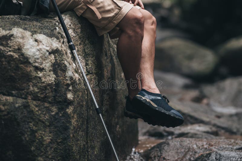 Hiker with Backpack Sitting on the Rock in Waterfall while a Rest ...