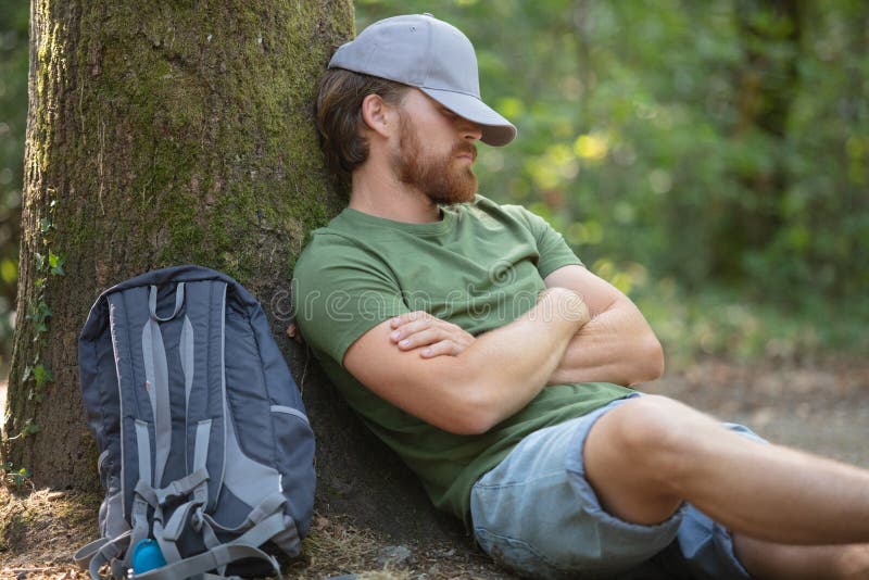 Hiker with Backpack Sleeping Against Tree in Forest Stock Image - Image ...