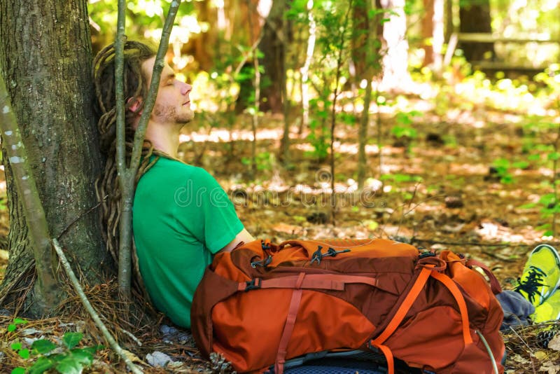 Hiker with Backpack Sleeping Against a Tree Stock Photo - Image of ...
