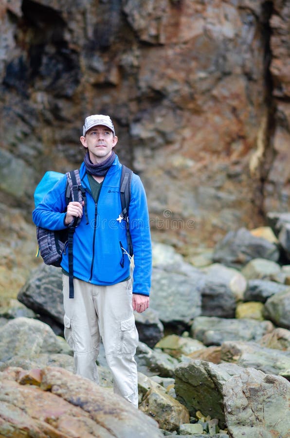 Hiker with Backpack Standing on Rocky Terrain Outdoors in Blue Jacket ...