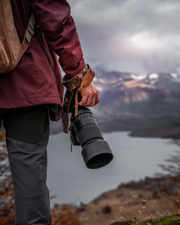 Hiker with a Camera and Backpack Standing on a Mountain Stock Image ...