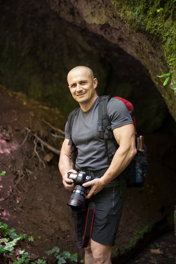 Hiker with Camera Near a Cave Stock Photo - Image of sunny, holiday ...