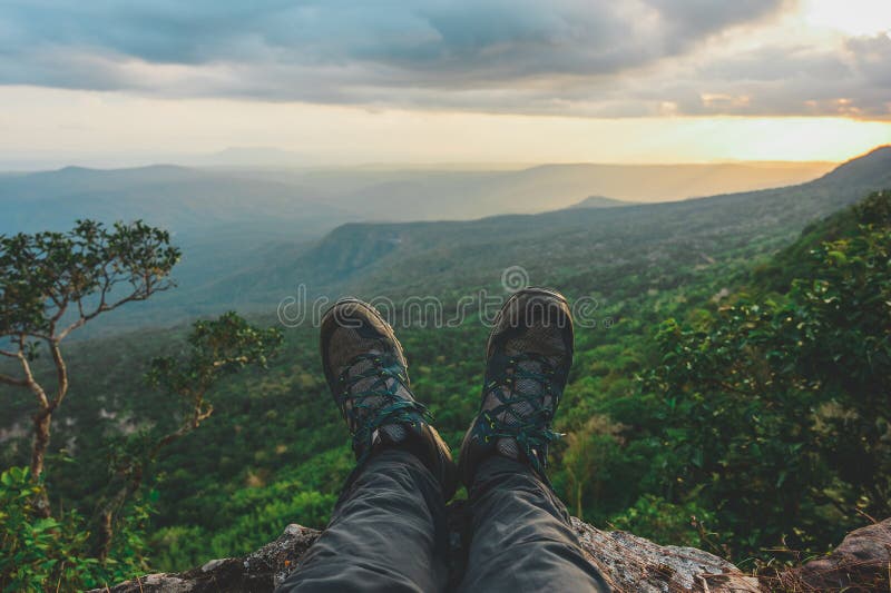 The Hiker Climbed, Rested, and Held His Feet Off the Edge of the Cliff ...