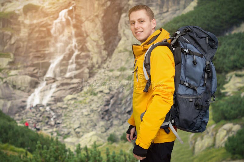 Hiker Man with Backpack Standing at Waterfall Stock Photo - Image of ...