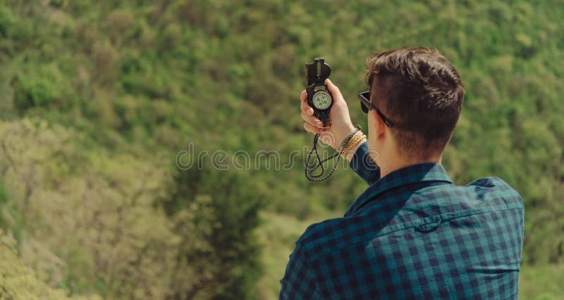 Hiker Man Searching Direction with a Compass Outdoor Stock Photo ...