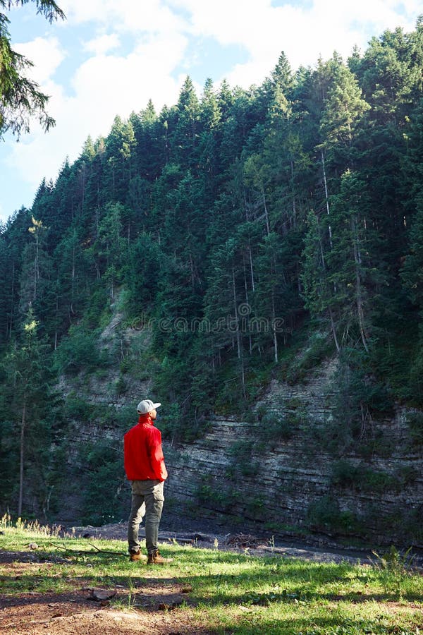 Hiker Observing Stone Cliff with Forest Stock Photo - Image of jacket ...