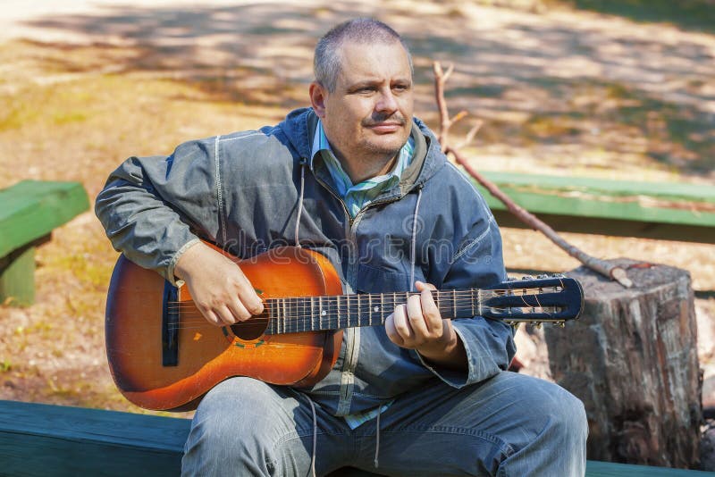 Hiker Playing Guitar Near the Fire Site Stock Image - Image of wildlife ...
