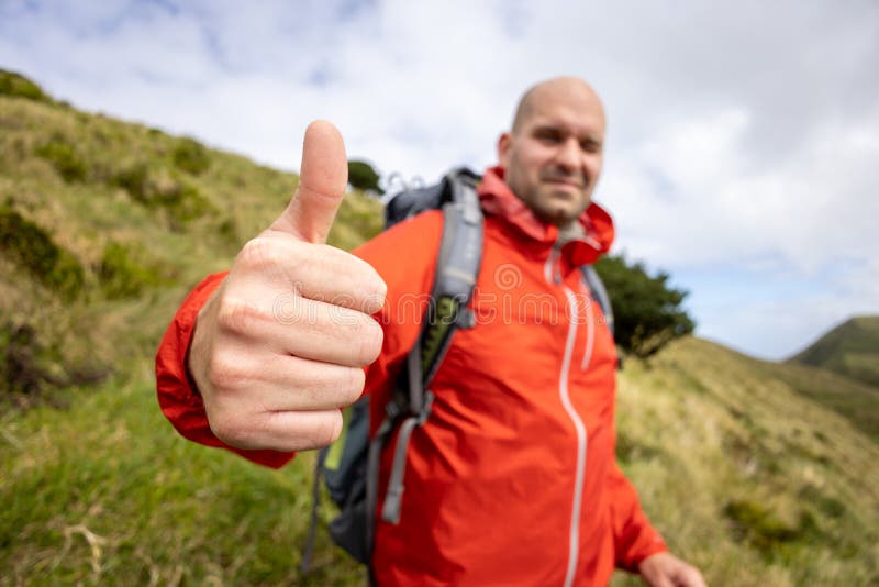 Hiker on a Hillside Giving a Thumbs Up Stock Photo - Image of trekking ...