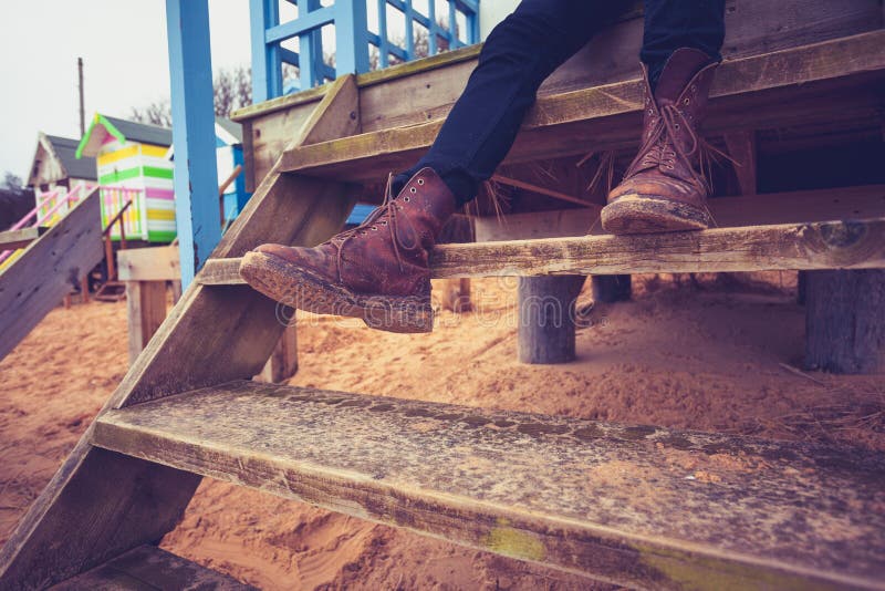 Hiker Relaxing on Steps of Beach Hut Stock Photo - Image of adult ...