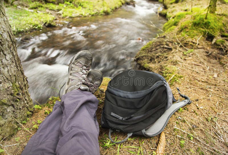 Hiker Resting in the Forest Next To River Stock Photo - Image of ...