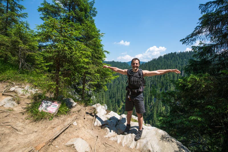 Hiker Standing on the Edge of a Very High Cliff Stock Photo - Image of ...
