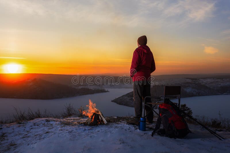 Hiker Standing Near Camp Fire and Looking Sun Over Horizon. Stock Photo ...