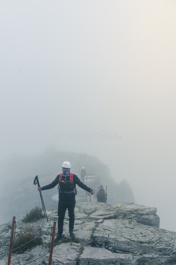 Hiker Standing on Top of a Cliff on a Hill Looking at the Horizon ...