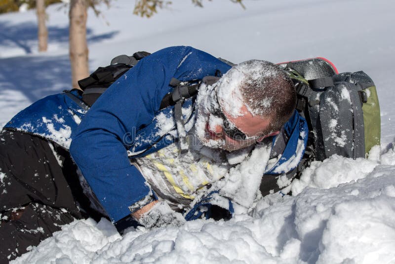 Hiker in Sunglasses with Backpack Lay Down with Snow on His Face in ...