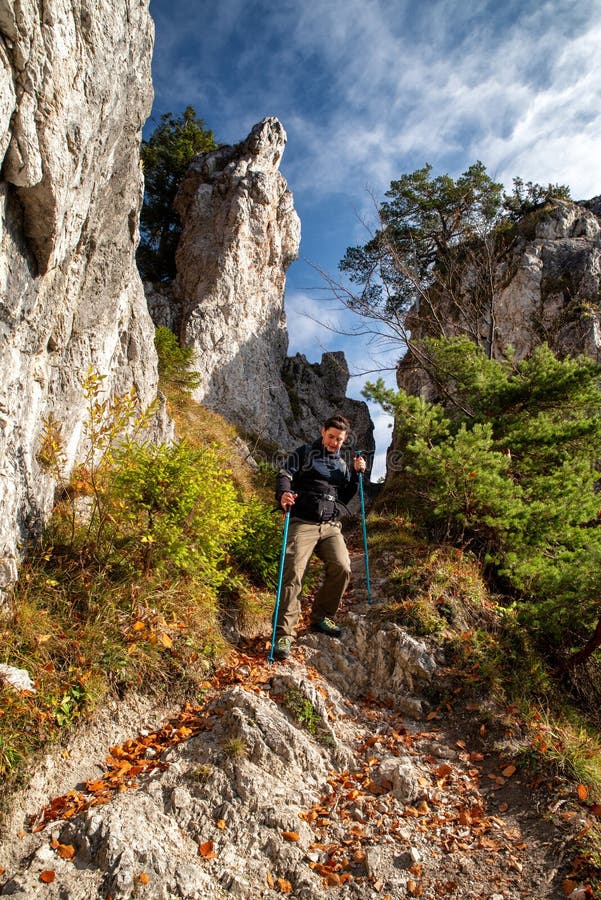 Hiker with Trekking Poles Walking between Rock Formations on Mountain ...
