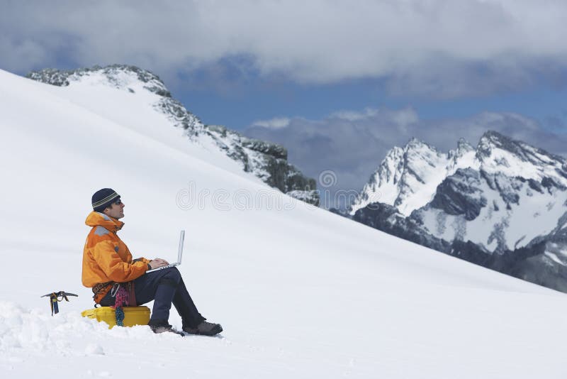Hiker Using Laptop on Snowy Mountain Slope Stock Photo - Image of ...