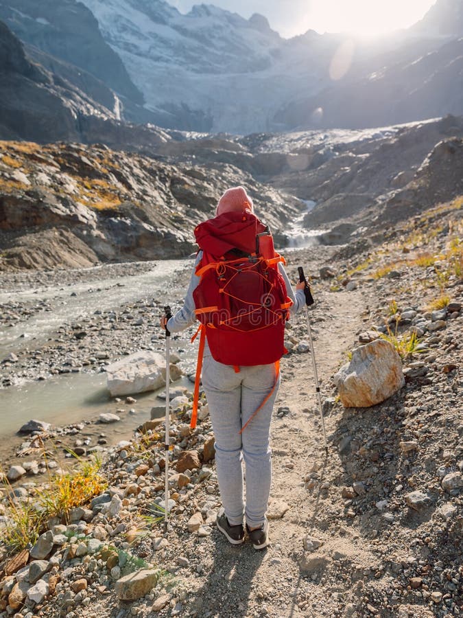 Hiker Woman with Backpack Walk in the Mountains. Mountain with Glacier ...