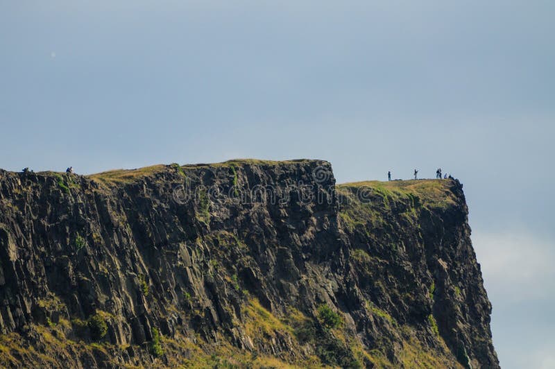 Hikers on Cliff Edge on Clear Day, Enjoying Stunning Views Stock Image ...