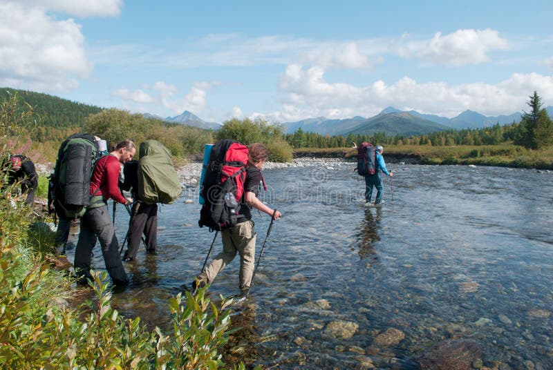 Hikers Crossing Mountain River Stock Image - Image of stream, high ...