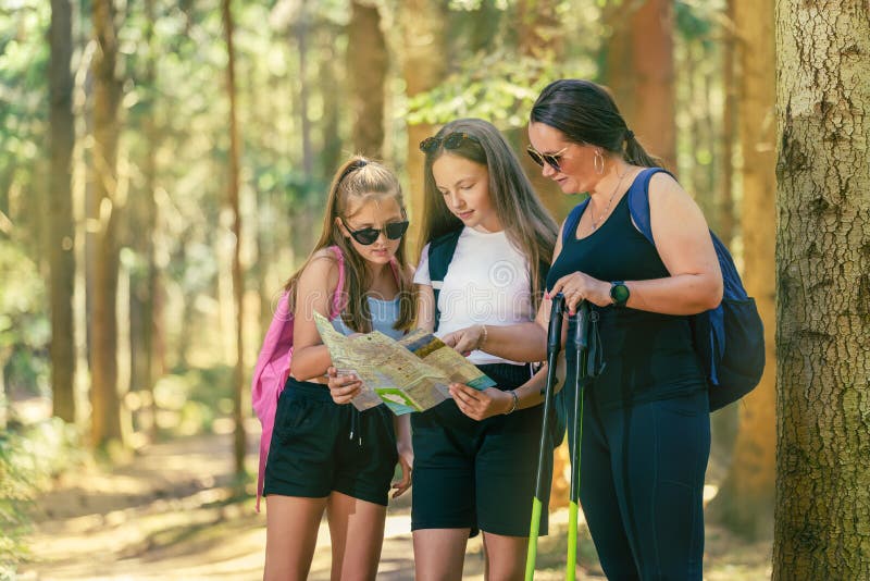 Hikers Study a Paper Map in the Forest Stock Image - Image of girl ...