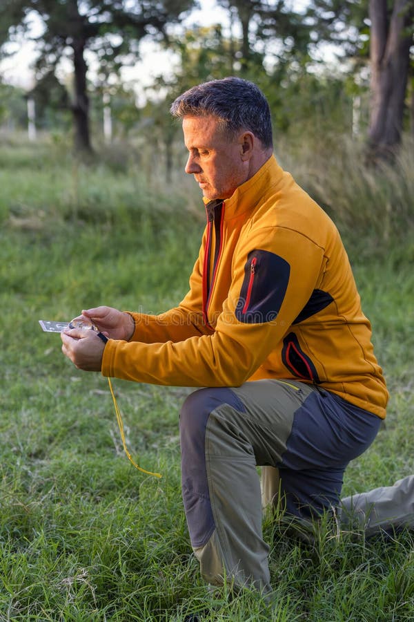 Hiking Enthusiast Checking Compass in Nature Stock Image - Image of ...