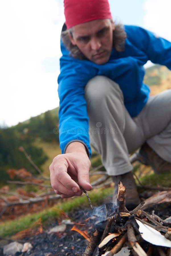 Hiking Man Try To Light Fire Stock Photo - Image of hike, extreme: 61878764