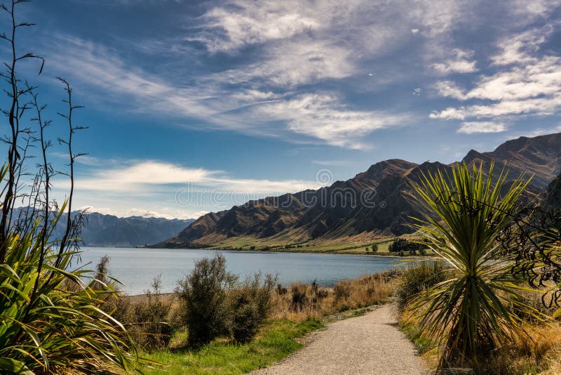 Hiking on the Pathway Around Lake Hawea Surrounded by Mountains Stock ...