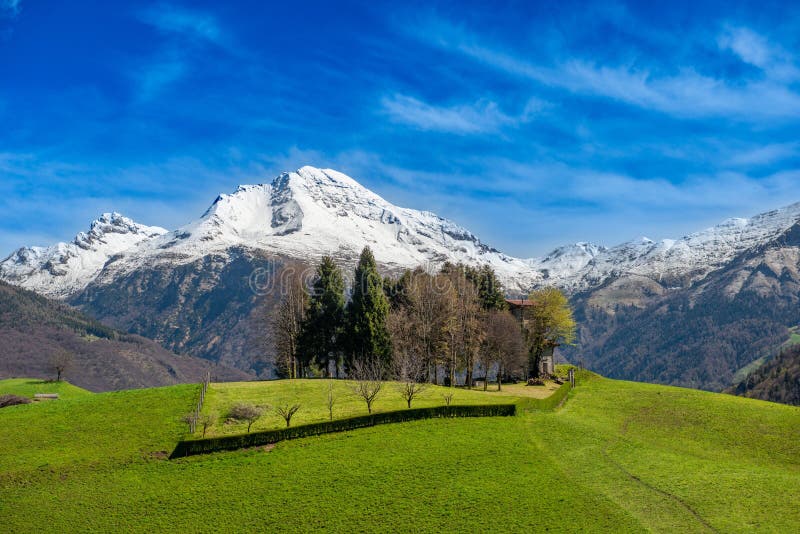 Hill in Spring with Snow Capped Mountains Stock Photo - Image of ...