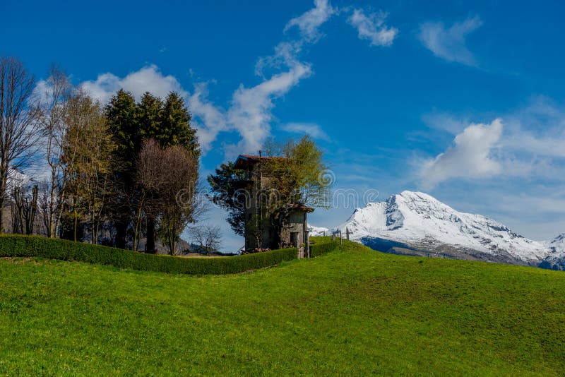 Hill in Spring with Snow Capped Mountains Stock Photo - Image of ...
