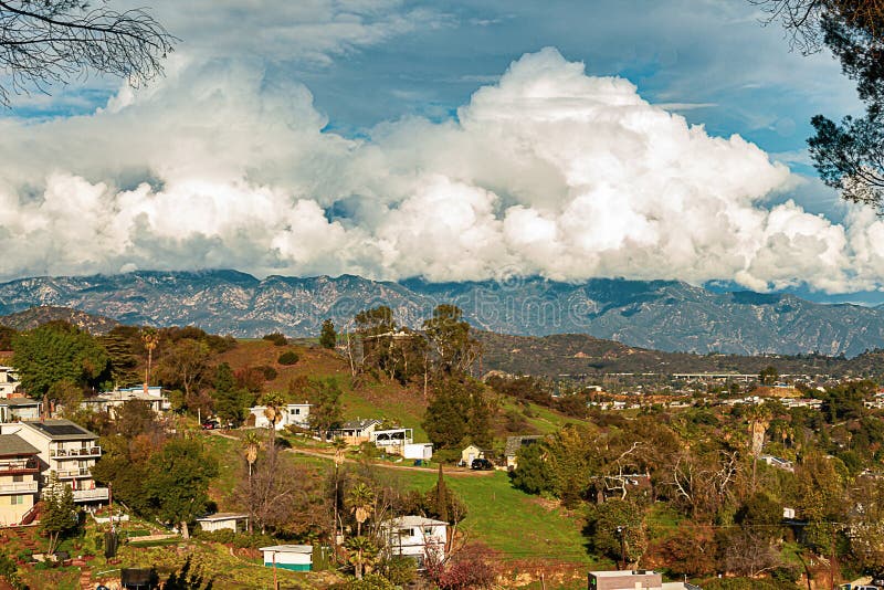 Hillside Homes Mountain Range with Huge Cumulus Nimbus Clouds Stock ...