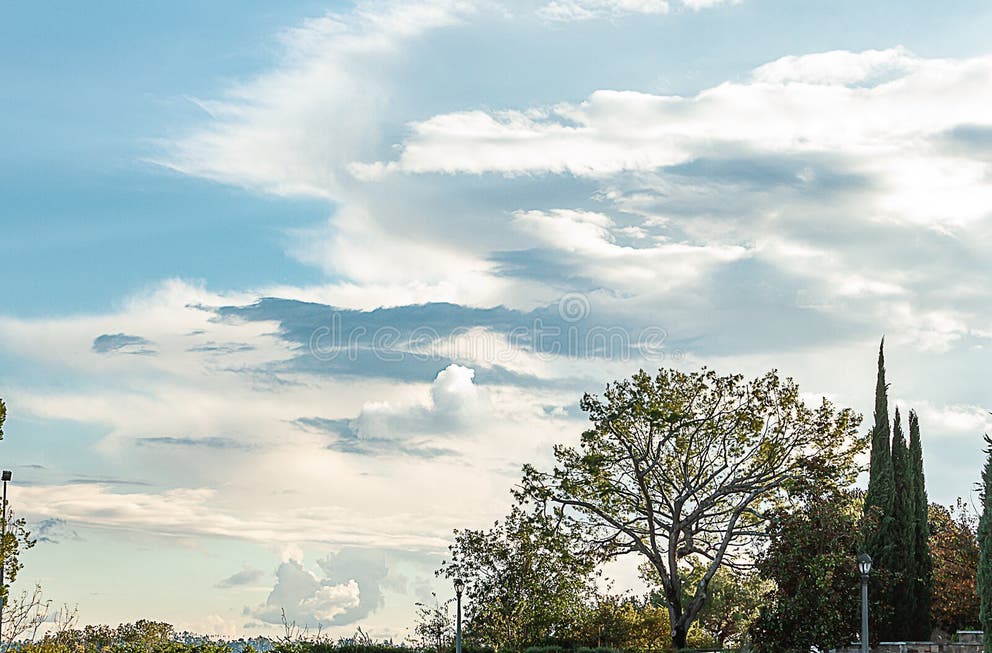 Hillside View of Panaramic Sky and Cloudscape, Lamp Post and Bench ...