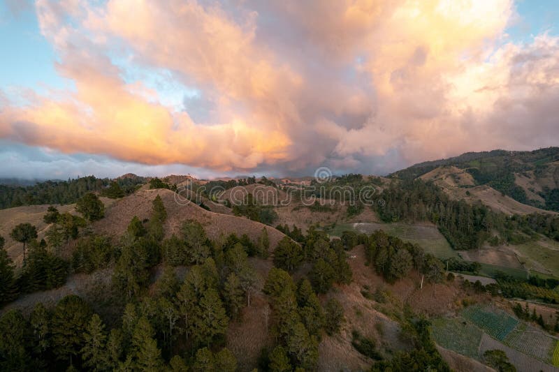 Hilly Landscape with Dramatic Clouds at Sunset. Stock Photo - Image of ...