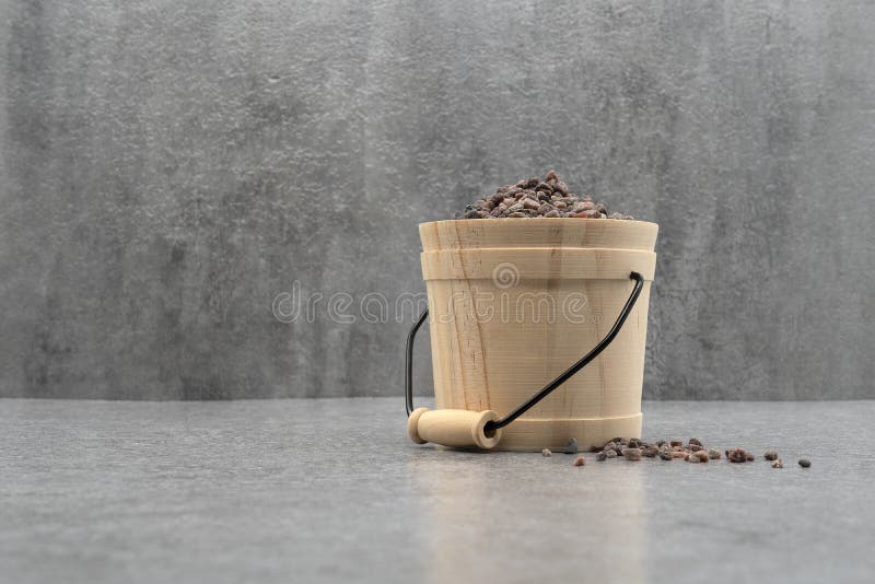 Himalayan Black Salt in Wooden Bucket on Stone Texture Background Stock ...