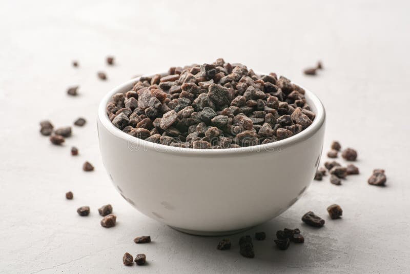 Himalayan or Indian Black Salt in Ceramic Bowl on Grey Concrete ...