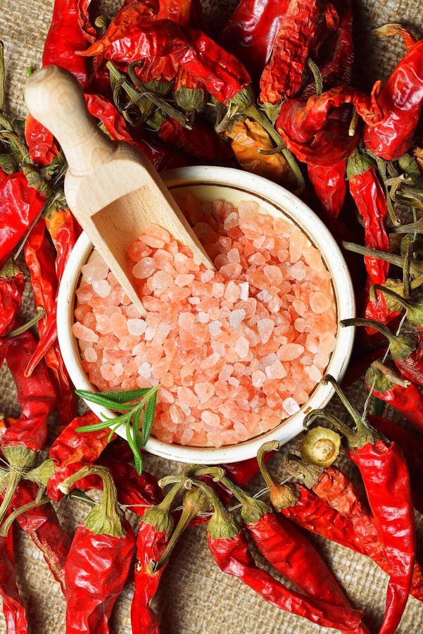 Himalayan Pink Salt in Ceramic Bowl and Dry Red Peppers Stock Photo ...