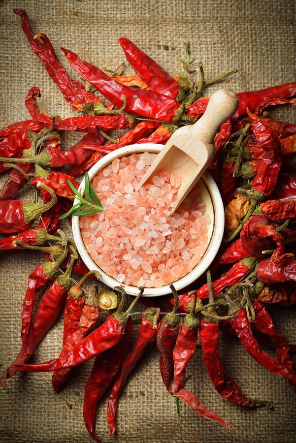 Himalayan Pink Salt in Ceramic Bowl and Dry Red Peppers Stock Image ...