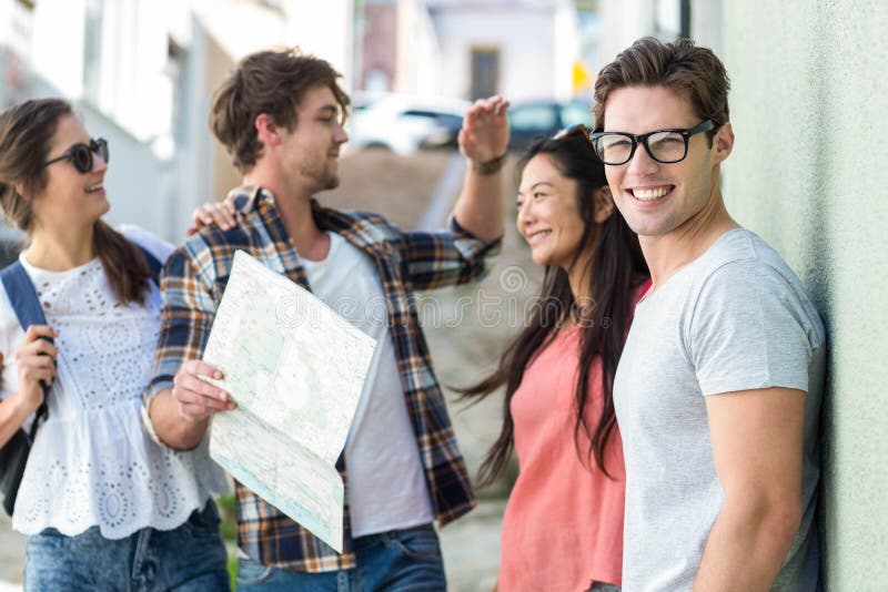Hip friends checking map stock image. Image of happy - 66435141